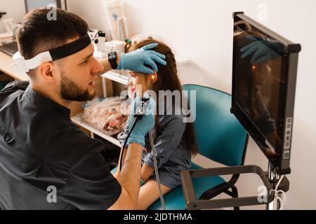 Ears endoscopy of child. Otoscopy procedure with otoscope. ENT doctor ...