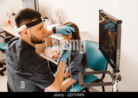 Ears endoscopy of child. Otoscopy procedure with otoscope. ENT doctor ...