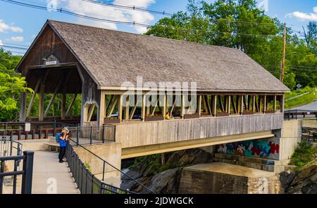 historic covered bridge over the Ottauquechee River in Quechee, Vermont ...