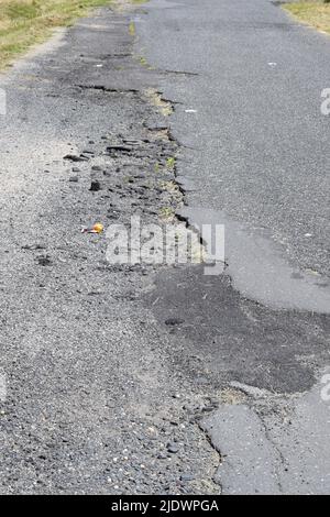 Pothole in cracked cement pavement sidewalk. Urban decay and neglect in ...