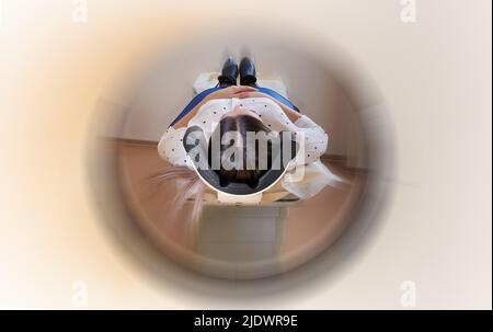 Patient undergoing a MRI (Magnetic Resonance Imaging) of the brain ...
