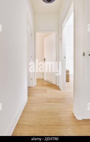 Corridor leading to a residential apartment with a parquet floor and ...