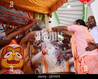 Hindu priests pour milk on top of deities Lord Jagannath, Balabhadra ...