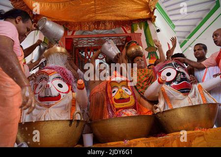 Hindu priests pour milk on top of deities Lord Jagannath, Balabhadra ...