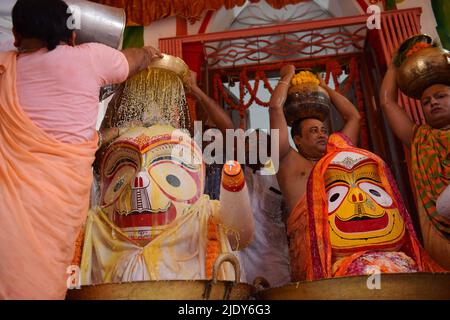 Hindu priests pour milk on top of deities Lord Jagannath, Balabhadra ...