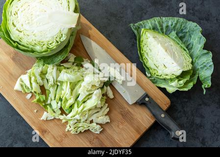 Chopped young fresh cabbage on a kitchen board Stock Photo - Alamy