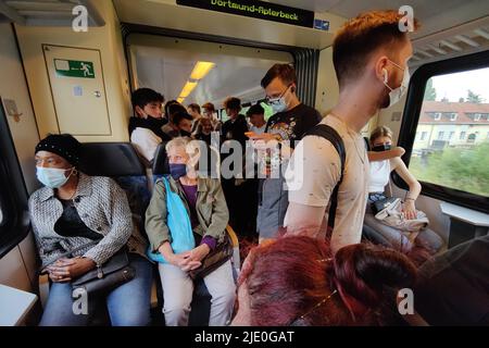 Very many people standing overcrowded in a local train, chaos in local ...