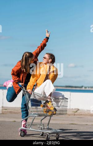 Happy friends are having fun with skates and longboards at straight ...