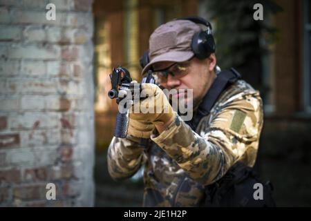 Training cycle in-service for civil police troops. Young man with gun ...