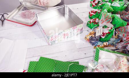 Step by step. Packaging homemade fudge and cookies into a Christmas ...