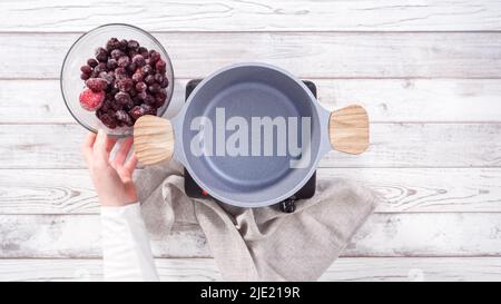 Step by step. Preparing mixed berry compote from frozen berries in a ...