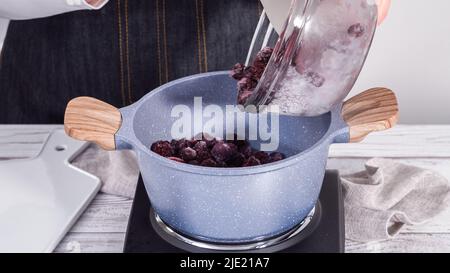 Step by step. Preparing mixed berry compote from frozen berries in a ...