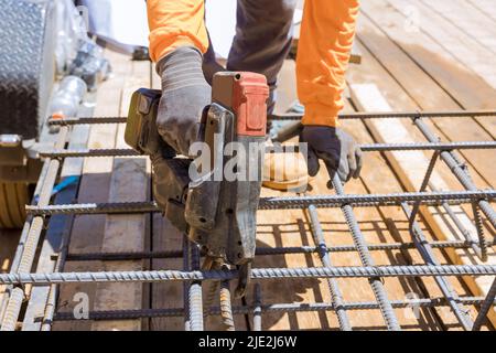 Construction worker twist steel bars with wire rod reinforcement into ...
