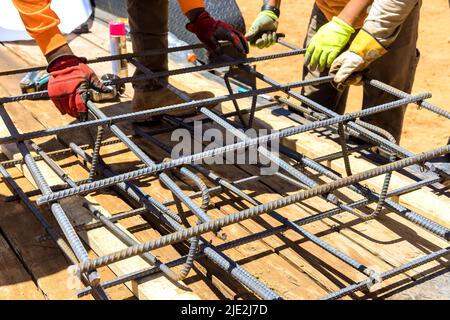 Construction worker twist steel bars with wire rod reinforcement into ...