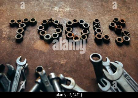 the word Tools written by nuts and a set of wrenches Stock Photo - Alamy
