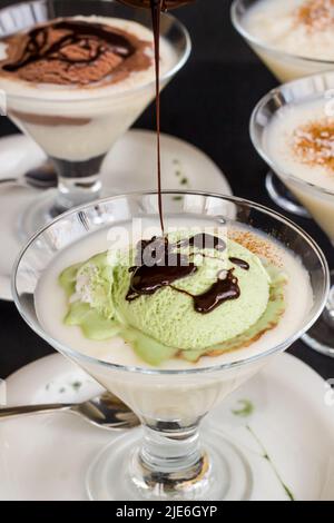 Homemade chocolate ice cream garnished with chocolate in a glass ice ...