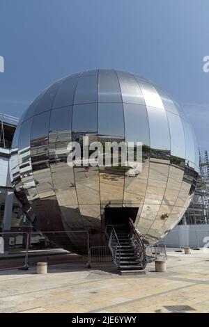 The Millennium Sphere reflecting blue sky and fluffy clouds in ...