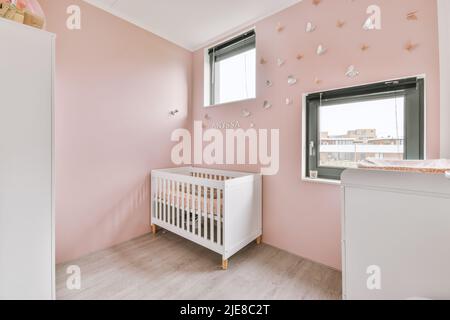 Chest of drawers in room near wall with print of clear water Stock ...