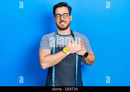 Handsome caucasian man with beard dressmaker designer wearing atelier ...
