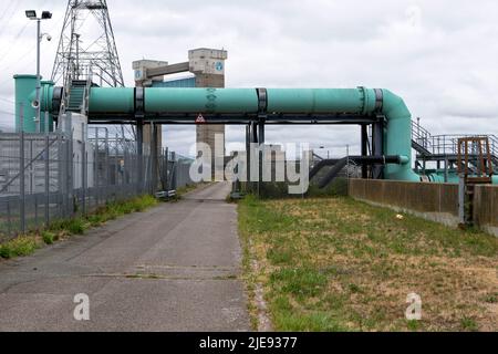 Overhead sewage treatment pipes beside the River Thames, Beckton Sewage ...