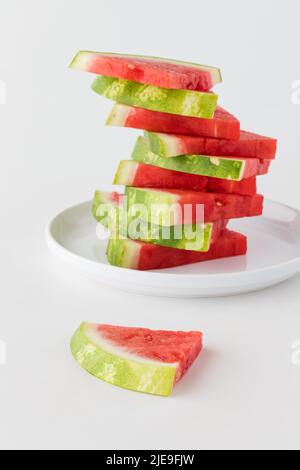 One Slices of Watermelon on a Plate with a pink fork over black ...
