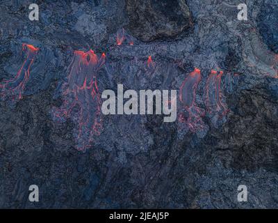 Magma flow of lava flows from the volcanic crater. View into the ...