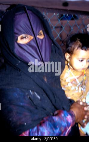A Bedouin woman in Oman wearing a traditional burqa Stock Photo - Alamy