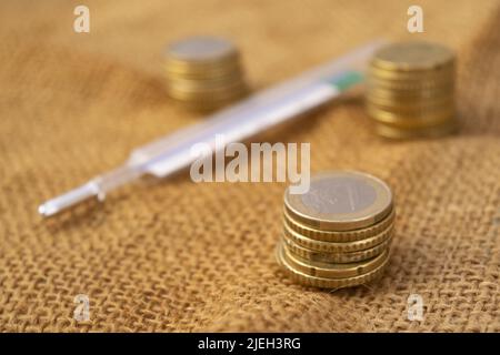 concept of economics of healthcare with a thermometer and the money ...