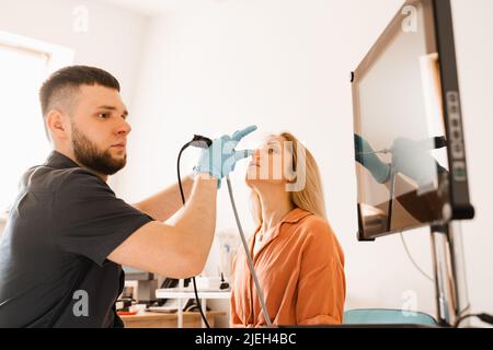 Nose endoscopy. Rhinoscopy procedure with rhinoscope. ENT doctor ...
