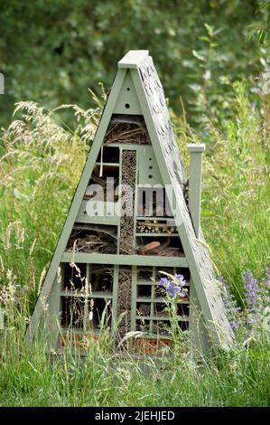 Triangular wooden bug hotel Stock Photo - Alamy