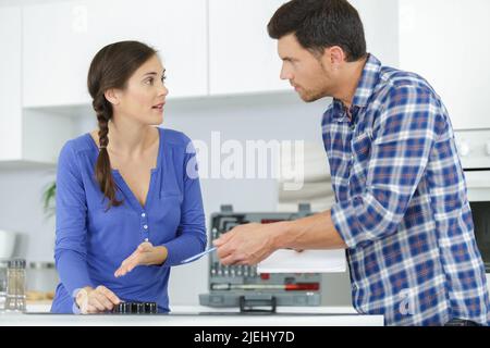 couple trying to fix a problem at home Stock Photo - Alamy