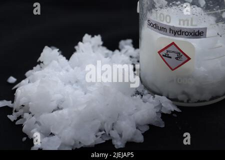caustic soda flake on black background Stock Photo - Alamy