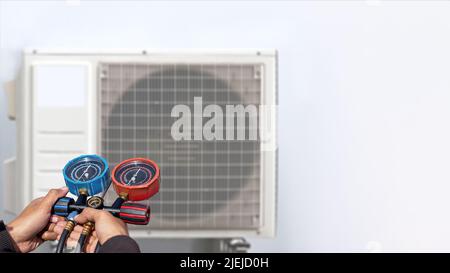 technician checks the operation of the air conditioner Stock Photo - Alamy