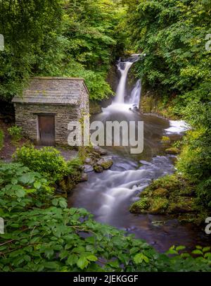 A river flowing over Rydal Falls in the Lake District National Park ...