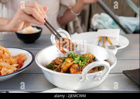 Spicy shrimp pot with various peppers and szechuan sauce table top view ...