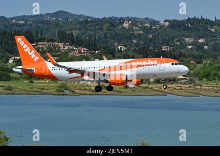 An Easyjet Airbus aircraft descending over trees on final approach ...