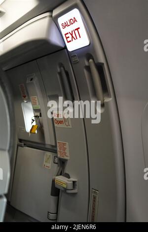 Emergency exit door in an airplane Stock Photo - Alamy