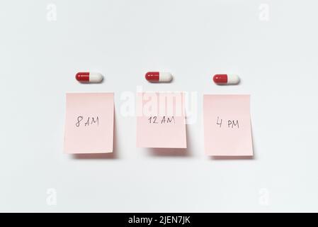 Pharmaceutical pills and medication time notes Stock Photo - Alamy