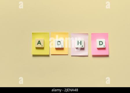 ADHD formed of scrabble tiles on sticky notes Stock Photo - Alamy