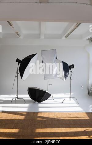 Professional lighting equipment, flashes, c-stands on a cyclorama in ...
