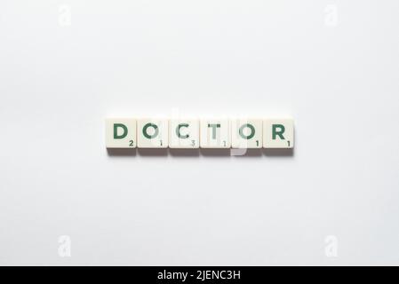 Doctor word formed of scrabble blocks on white background Stock Photo ...