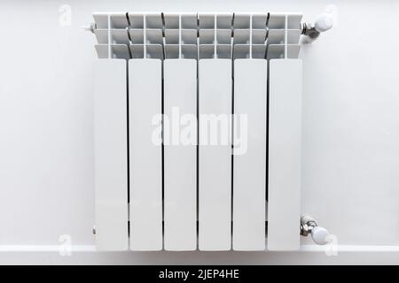 sectional radiator of the heater on the wall in room, heating pipes ...