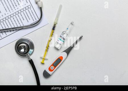Monkeypox vaccine, syringe and stethoscope on yellow background ...