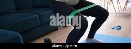 Happy woman does exercises with elastic at the gym Stock Photo - Alamy