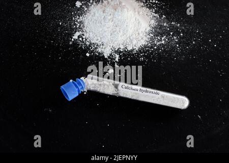 Calcium hydroxide in test tube and black background Stock Photo - Alamy