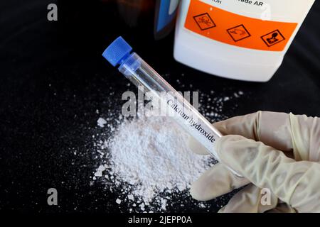 Calcium hydroxide in test tube and black background Stock Photo - Alamy
