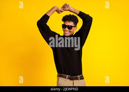 Photo of funky charming dark skin man wear black sweater dancing ...