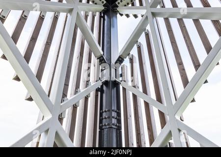 Massive steel beams end-to-end with bolts and nuts on the construction ...