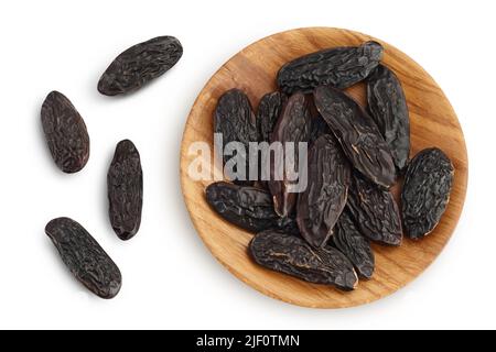 Tonka bean in wooden bowl isolated on white background with full depth ...