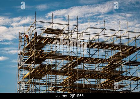 Temporary scaffolding surrounds the construction of a tower on the ...